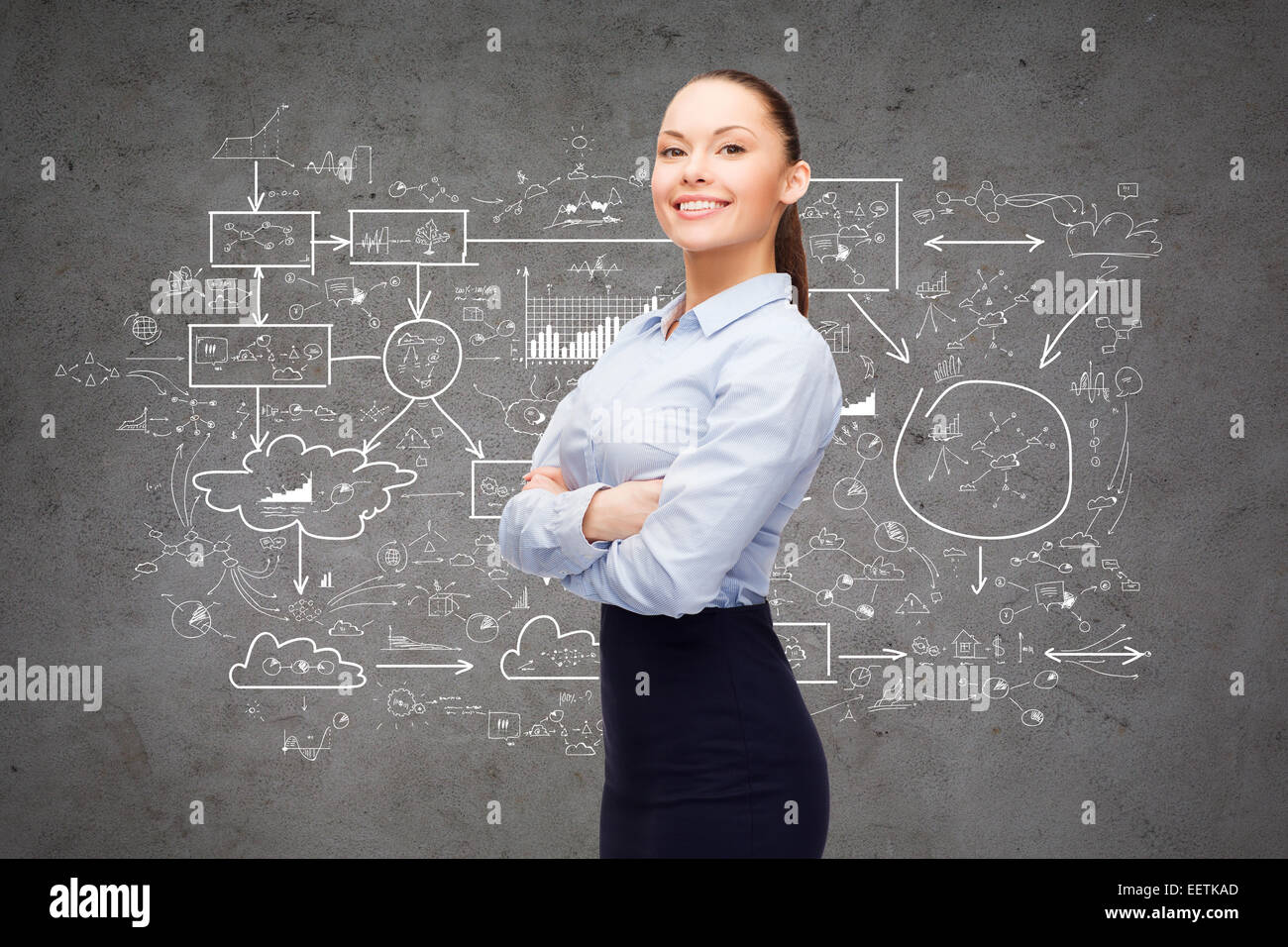 young smiling businesswoman with crossed arms Stock Photo - Alamy