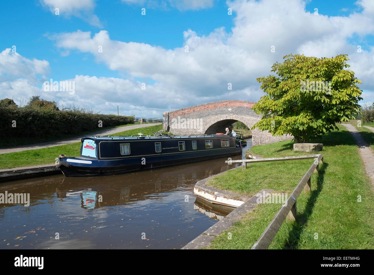A narrowboat passing under New Marton Bridge on the Llangollen Canal ...