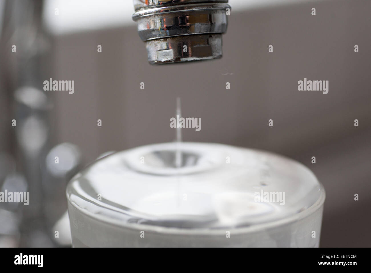Sink in kitchen with tap and glass of water Stock Photo - Alamy