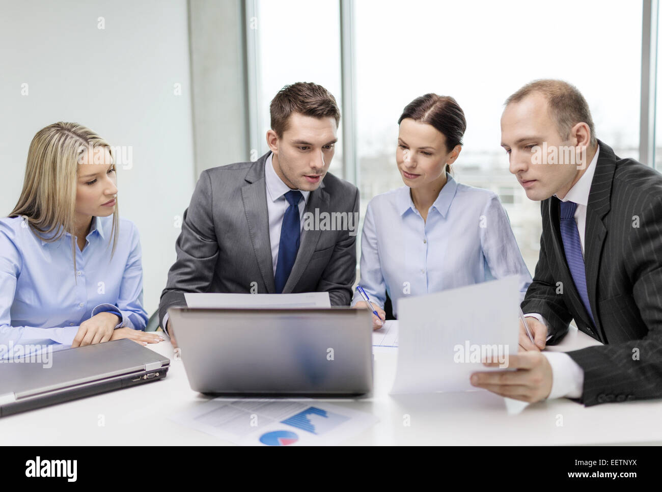business team with laptop having discussion Stock Photo - Alamy