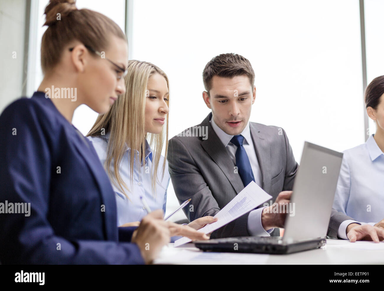 business team with laptop having discussion Stock Photo - Alamy