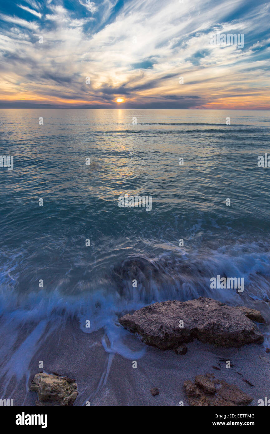 Fine white wispy clouds in sky at sunset over Gulf of Mexico at ...