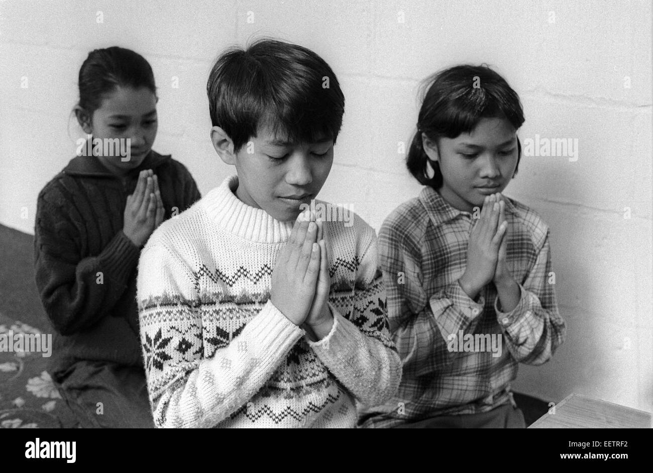 Three children praying Stock Photo - Alamy