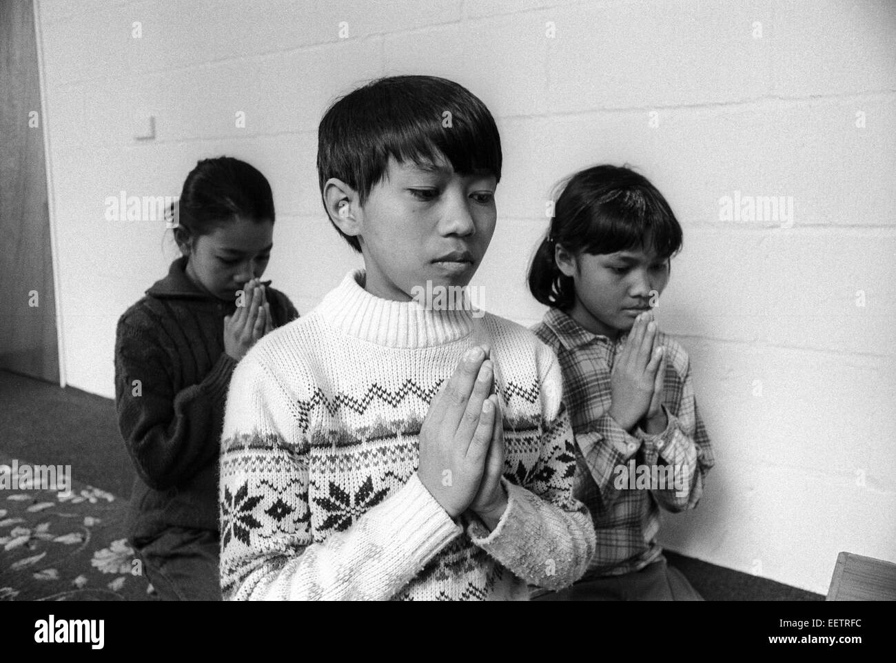 Three Asian children praying Hindu altar Stock Photo - Alamy