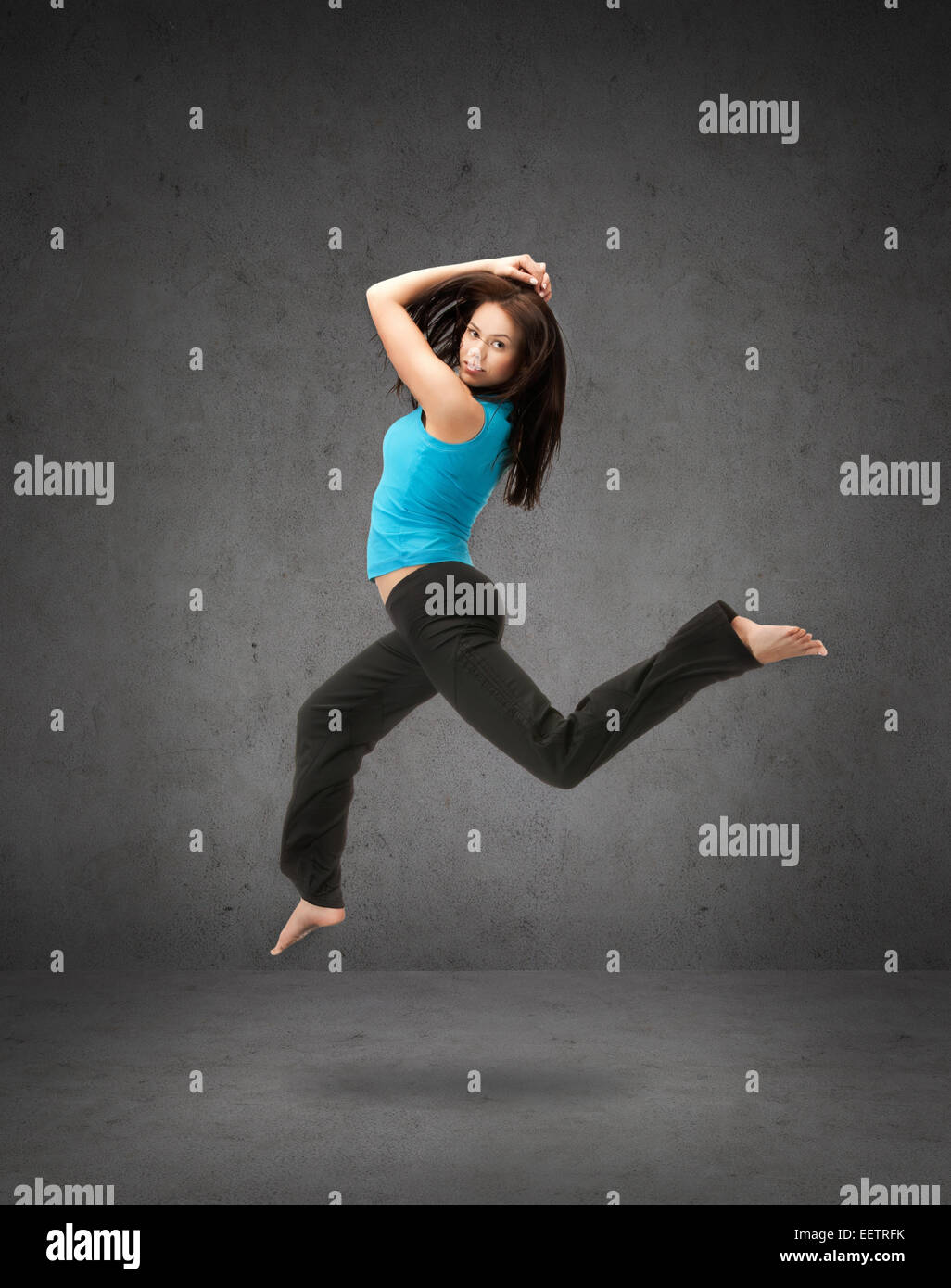 Young woman jumping concrete wall hi-res stock photography and images ...