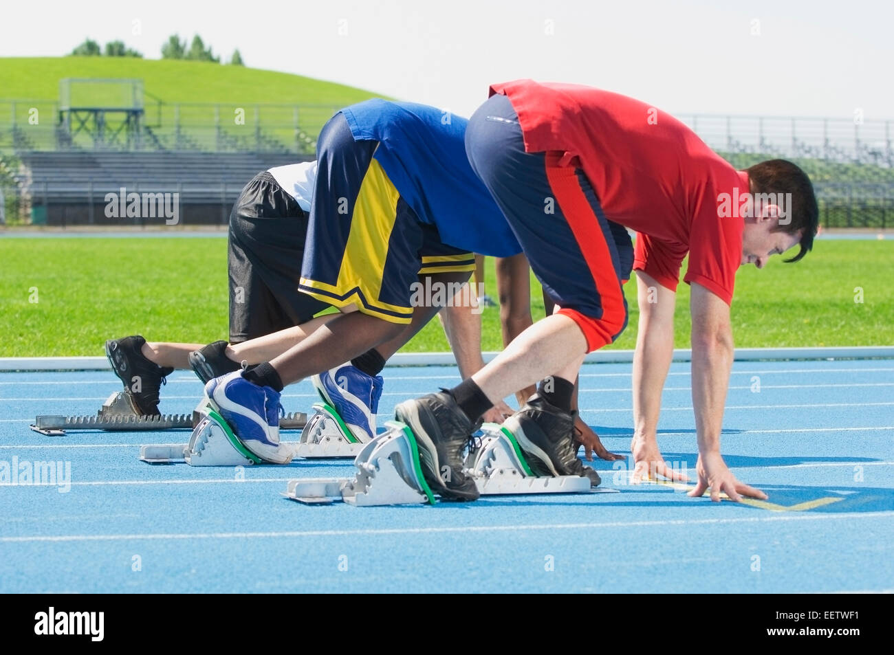 Runners on a track at start line Stock Photo - Alamy