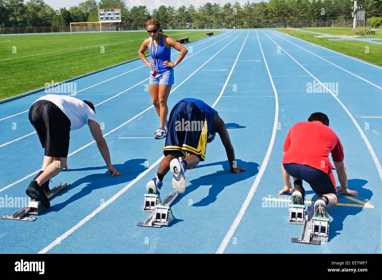 Runners on a track at start line Stock Photo - Alamy