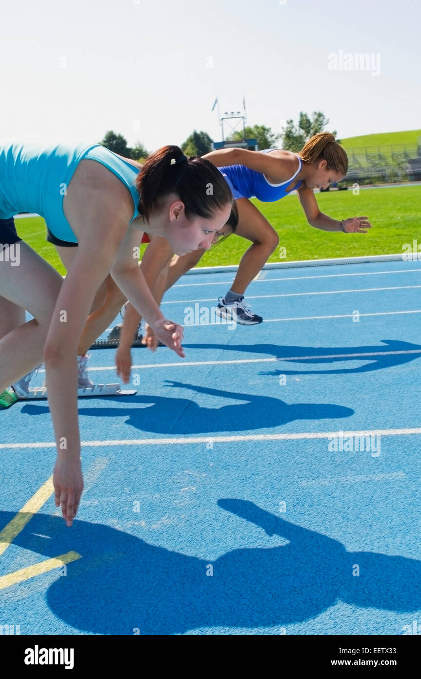 Runners on a track at start line Stock Photo - Alamy
