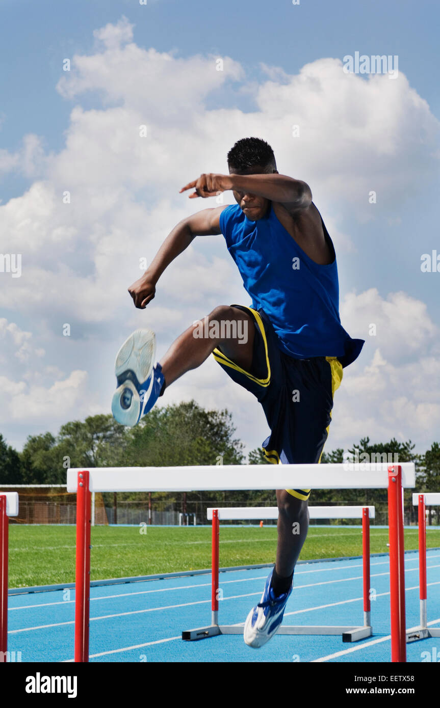 Man jumping hurdles on a track Stock Photo - Alamy Man jumping hurdles on a track Stock Photo - Alamy