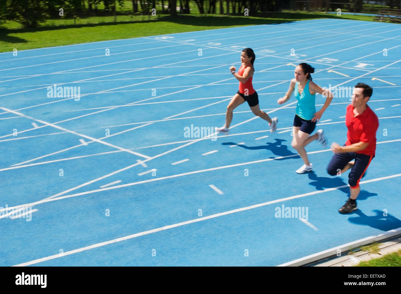 Runners racing on a race track Stock Photo - Alamy