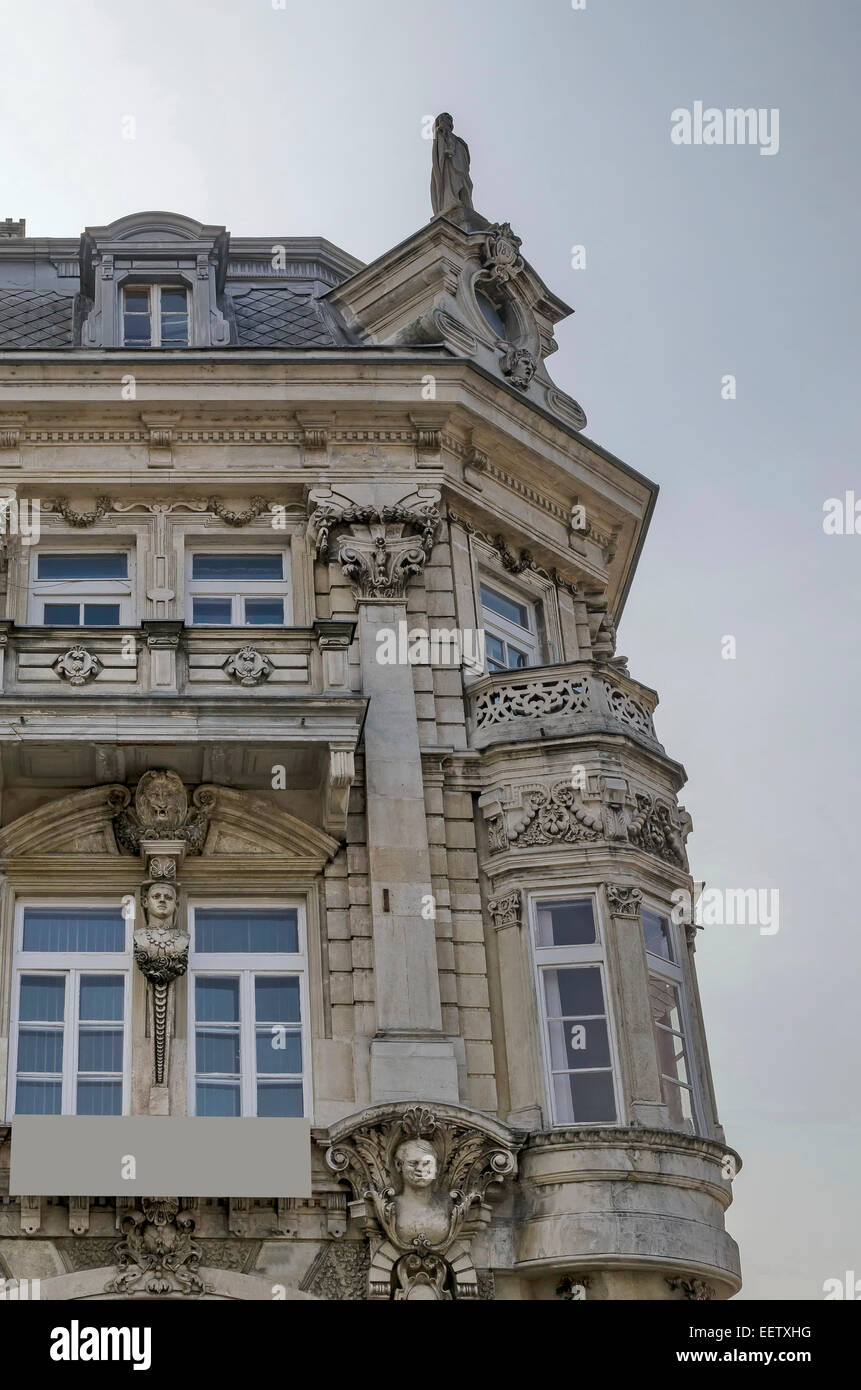 Fragment of ancient building with rich decoration and oriel in center ...
