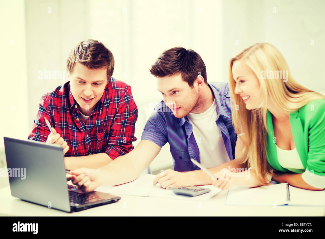 smiling students looking at laptop at school Stock Photo - Alamy