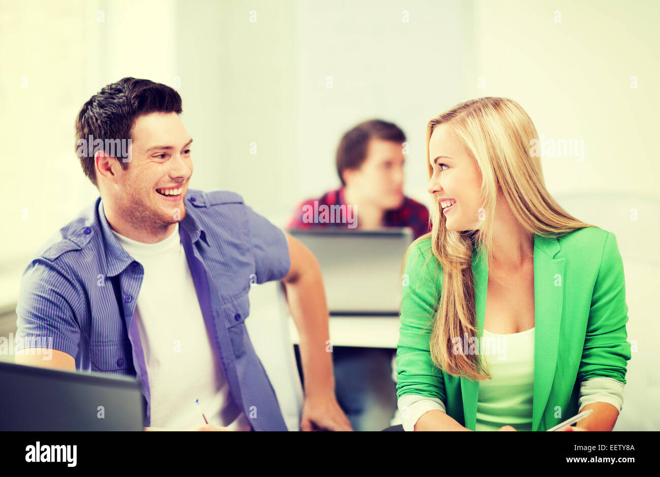 smiling students looking at each other at school Stock Photo - Alamy