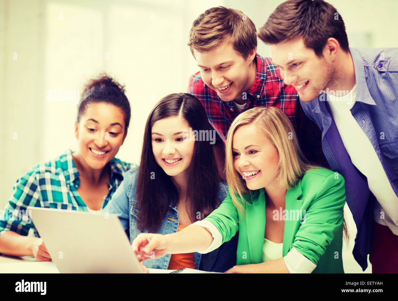 smiling students looking at laptop at school Stock Photo - Alamy