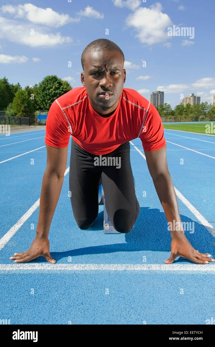 Runner on a track at start line Stock Photo - Alamy