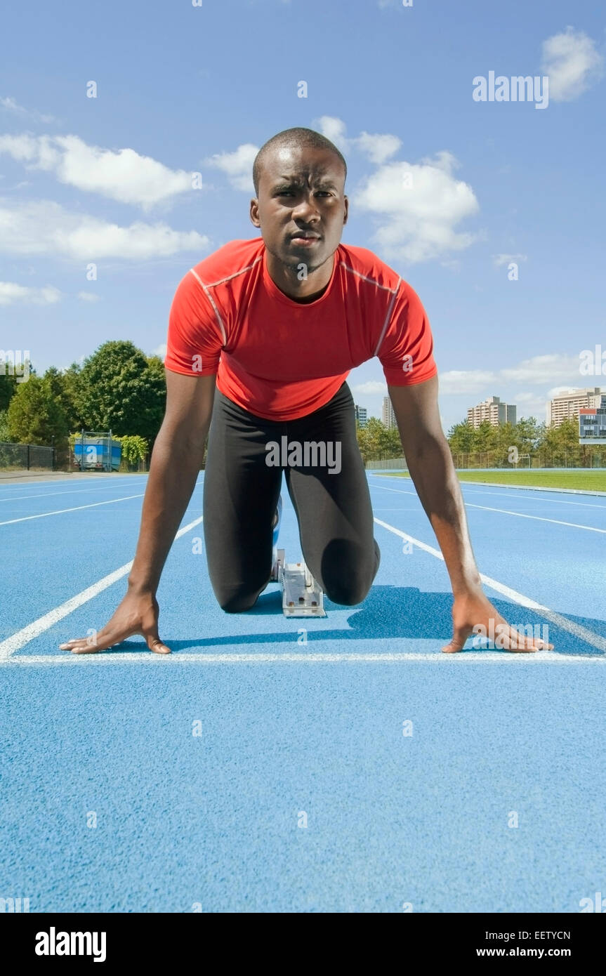 Runner on a track at start line Stock Photo - Alamy