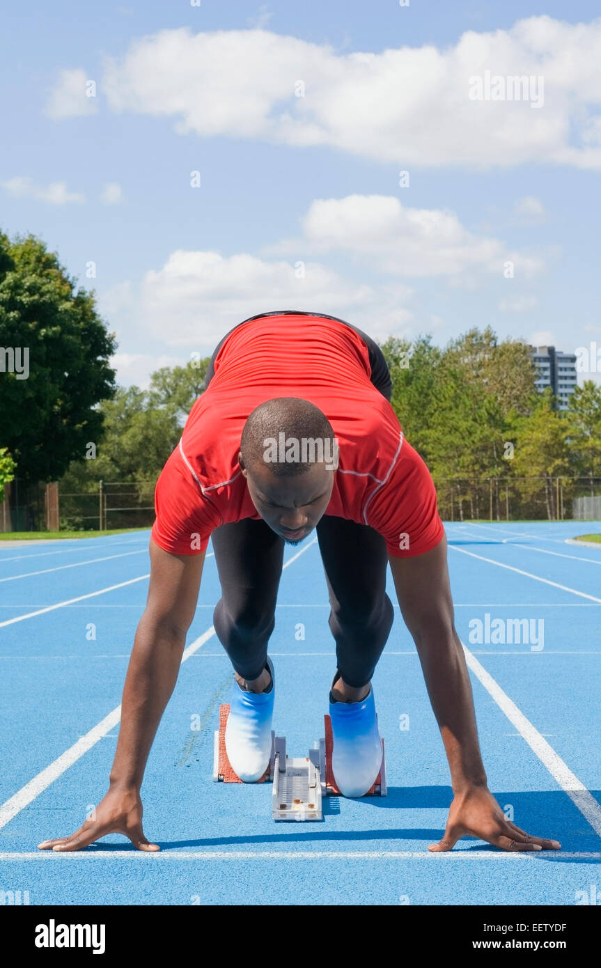 Runner on a track at start line Stock Photo - Alamy