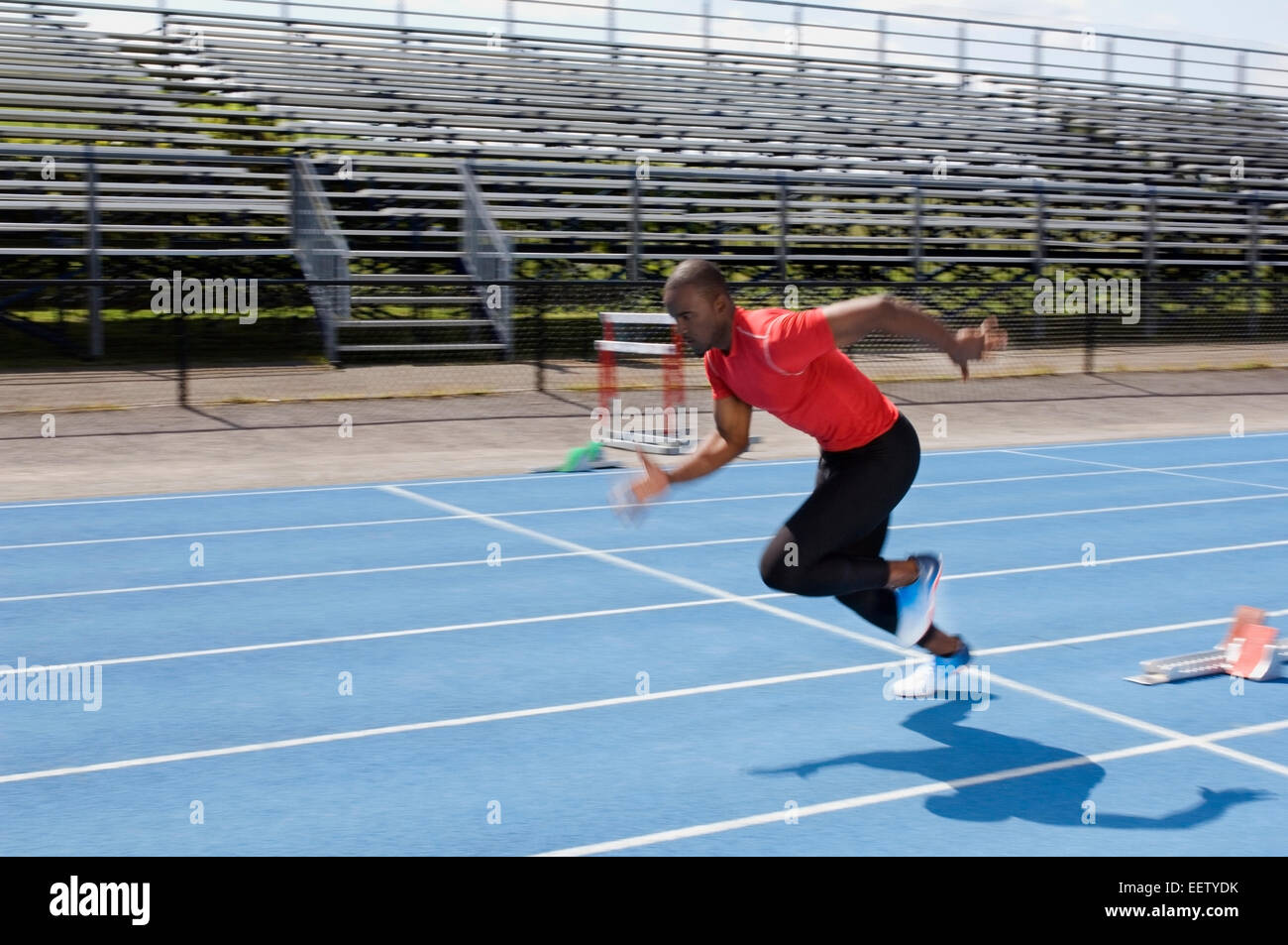Runner on a track at start line Stock Photo - Alamy
