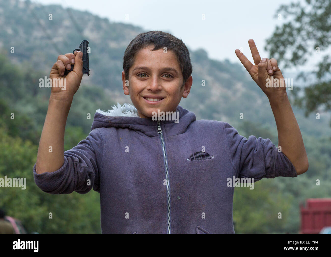 Yezedi Refugee From Sinjar Holding A Gun Toy, Lalesh Temple, Kurdistan ...