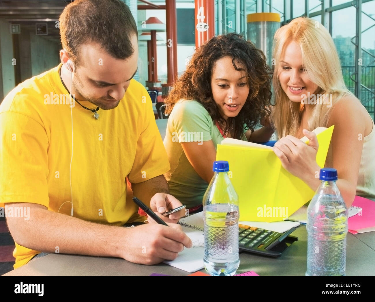 College students working on assignments and studying together Stock ...