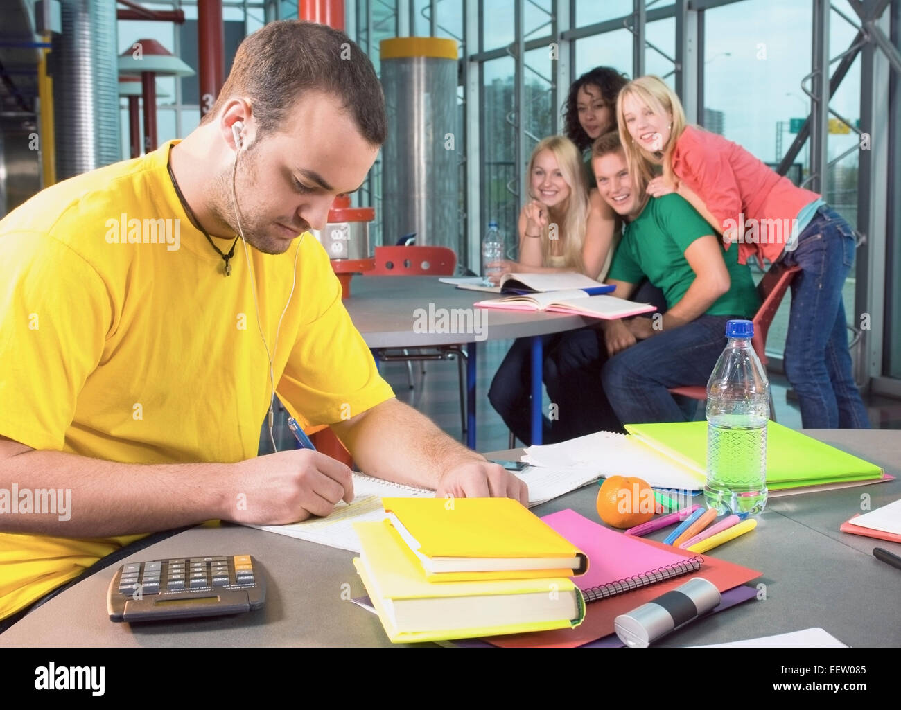 Male college student working on assignment Stock Photo - Alamy