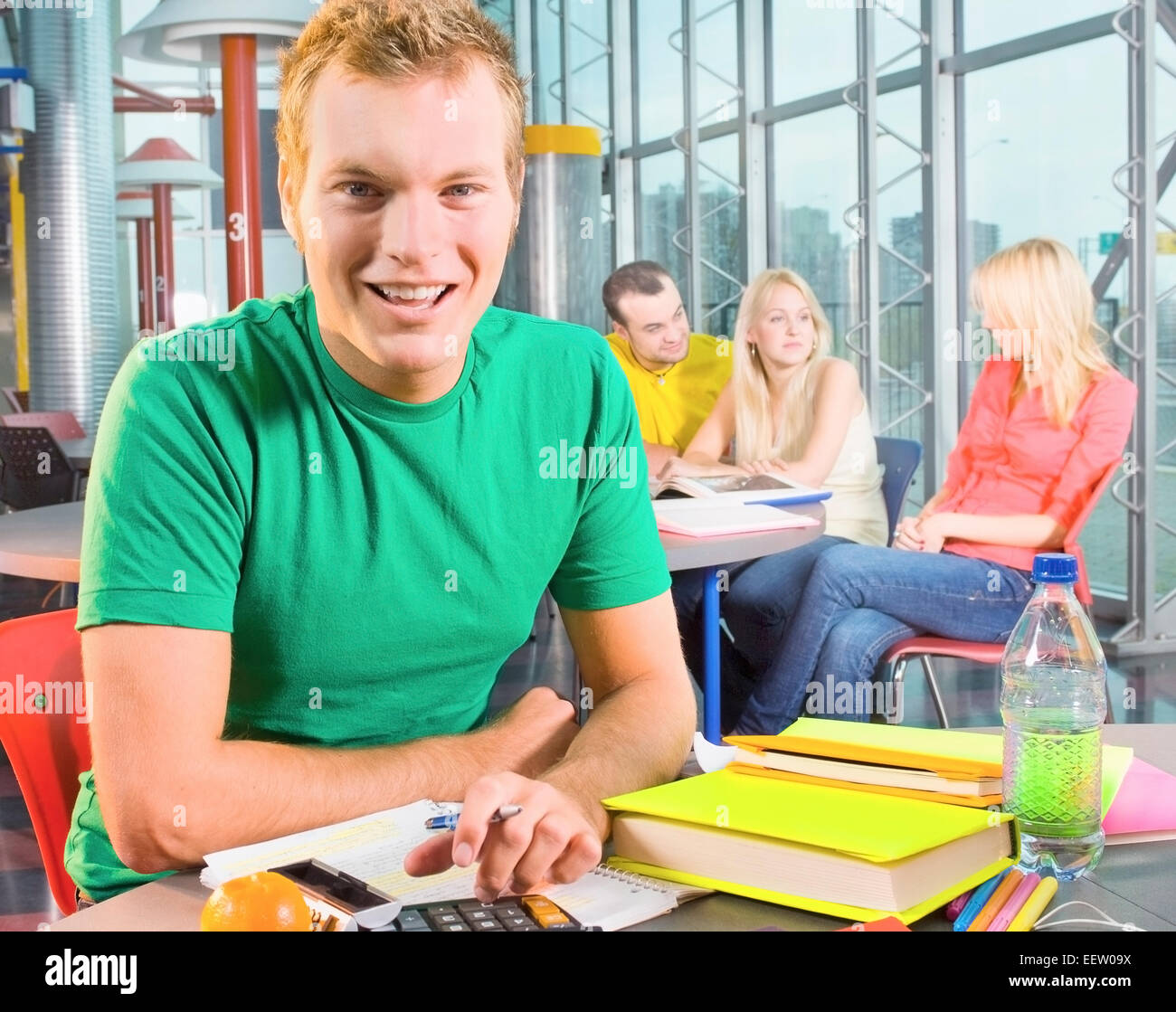 Male college student working on assignment Stock Photo - Alamy