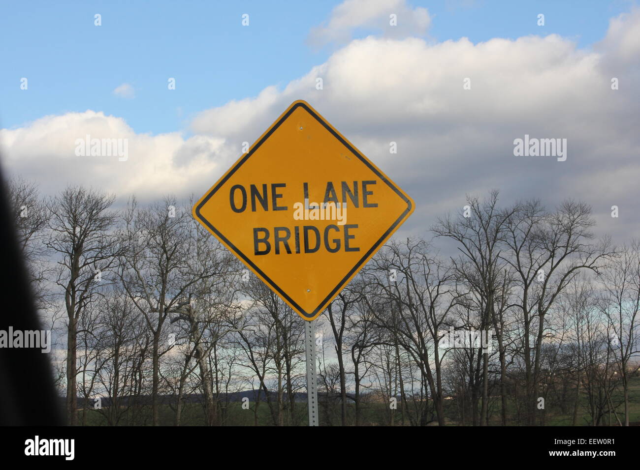 Yellow warning sign warning of a one Lane Bridge ahead Stock Photo - Alamy