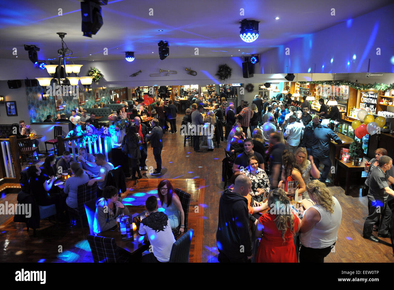 Crowded pub full of people drinking and socialising before Christmas ...