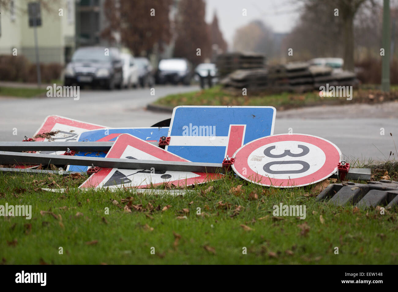 A pile of traffic signs lie by the side of a road as repairs are ...