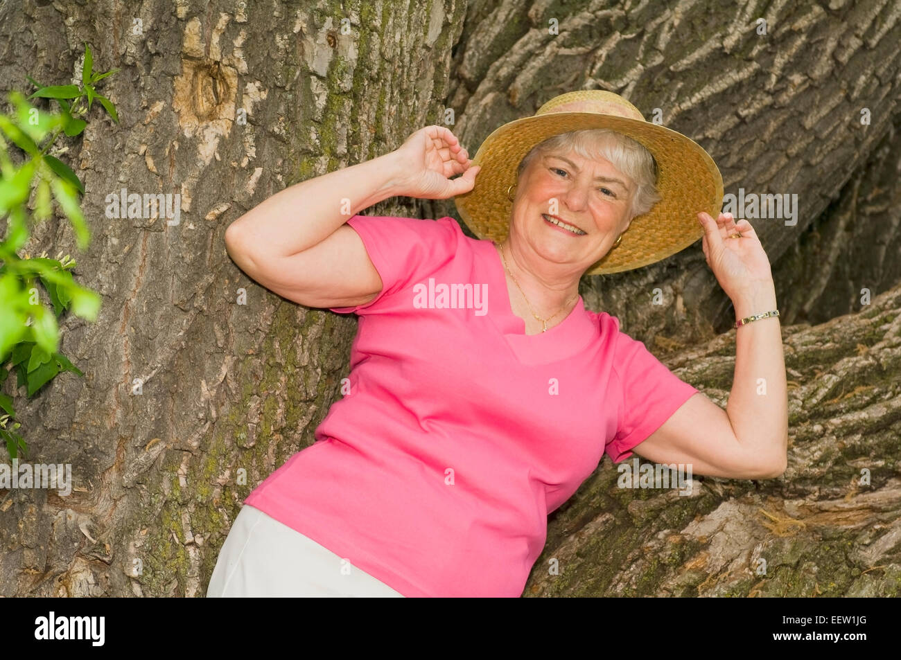 Senior woman leaning against tree hi-res stock photography and images ...