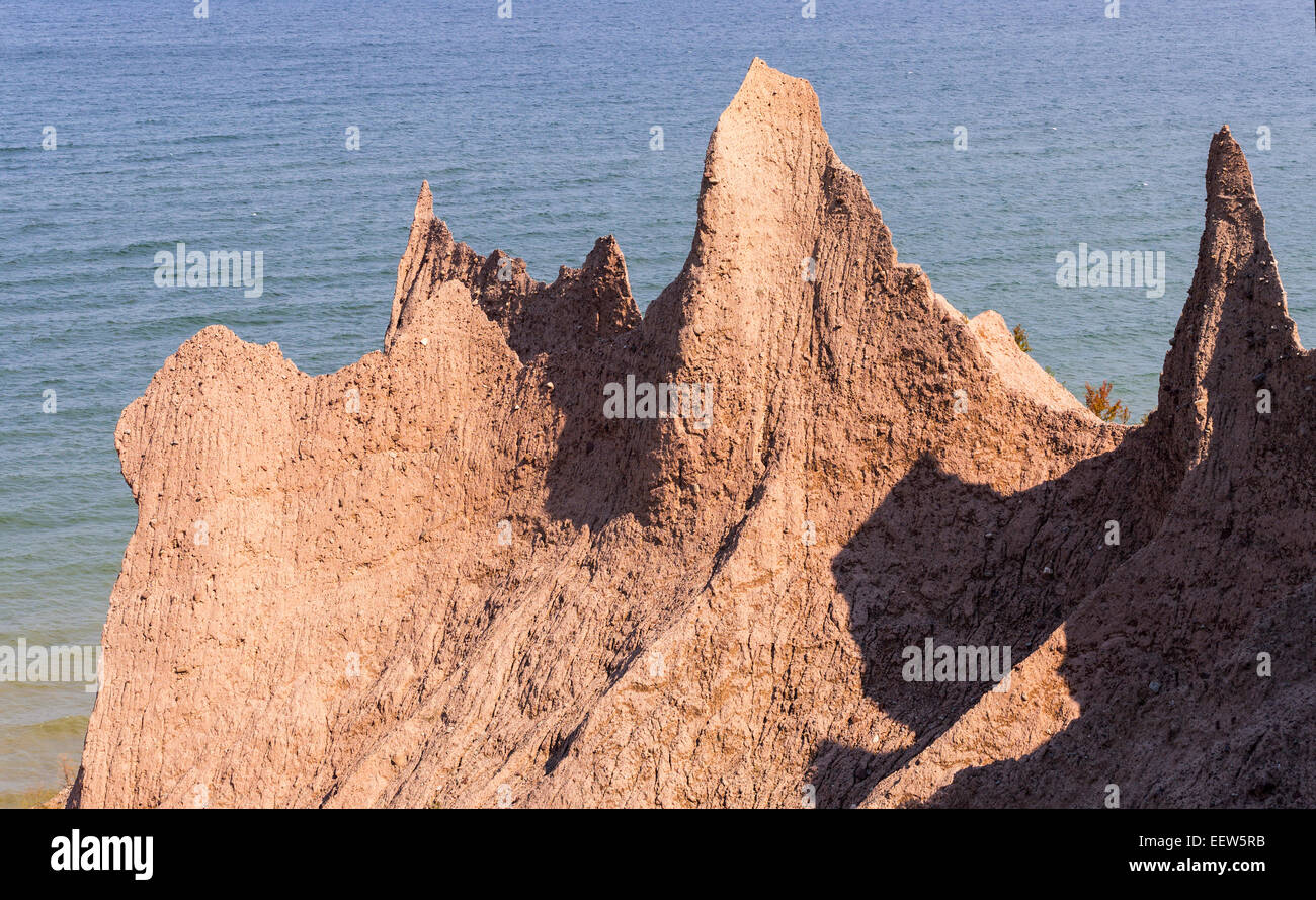 Clay Bluffs eroding along the shore of Lake Ontario. Pink chimneys of ...