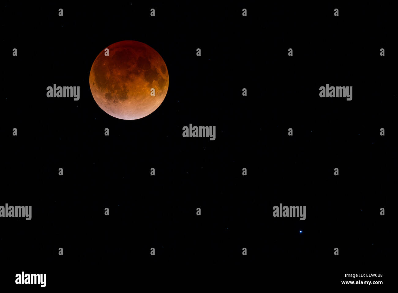 Red Blood Moon caused by total lunar eclipse. Many visible faint stars ...