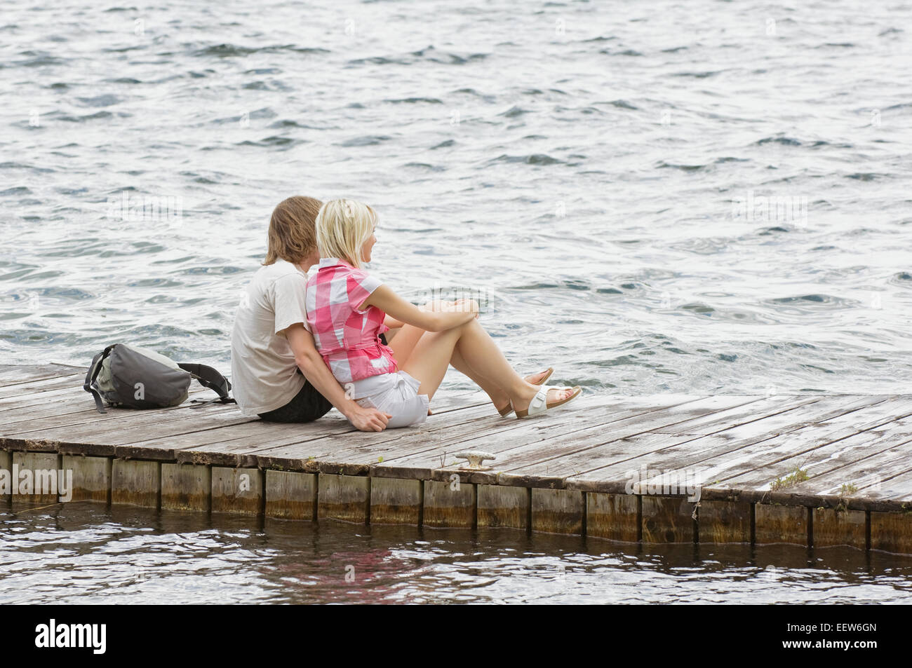 Back of two people sitting on dock hi-res stock photography and images ...