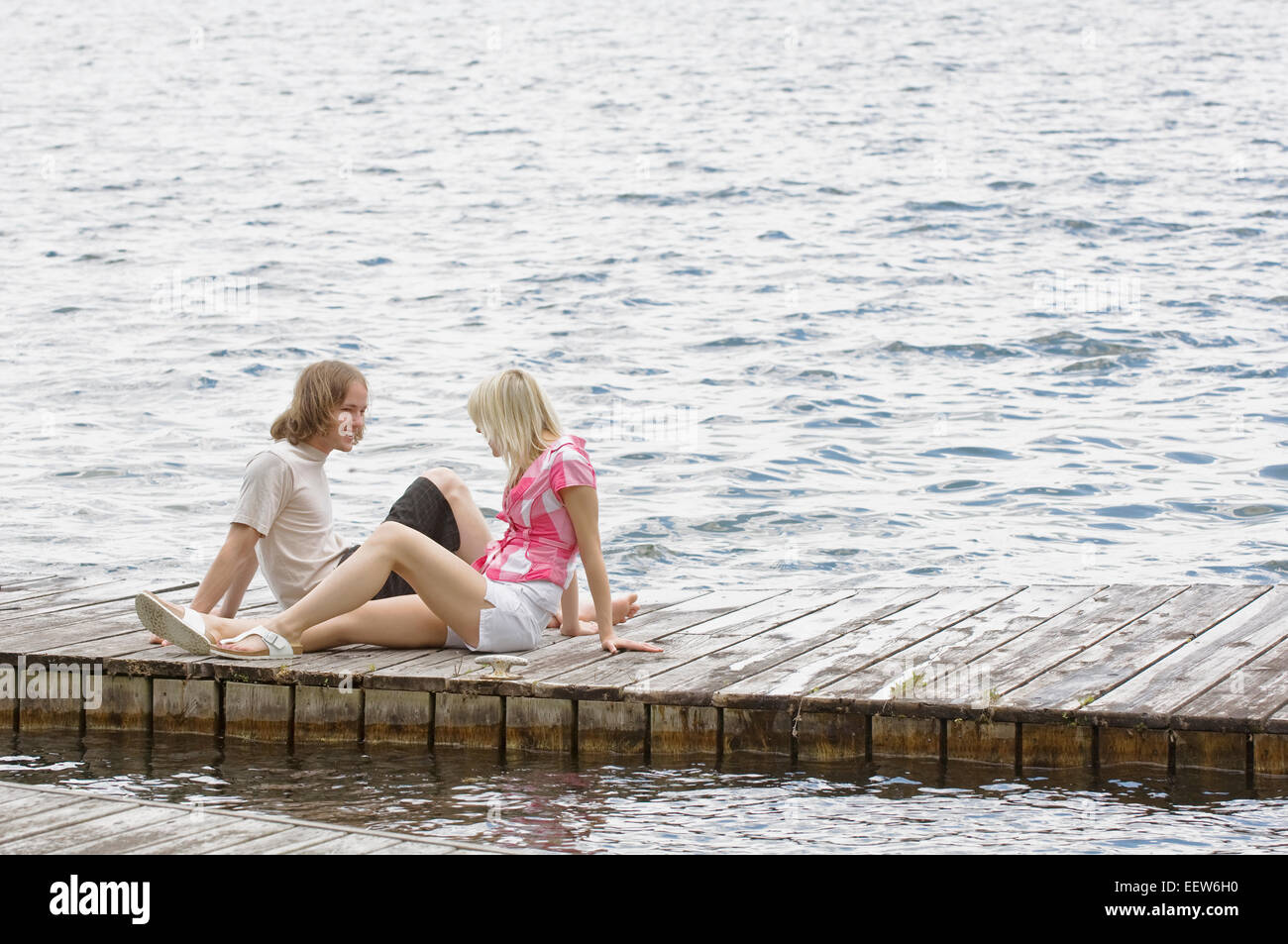 Man sitting on dock hi-res stock photography and images - Alamy
