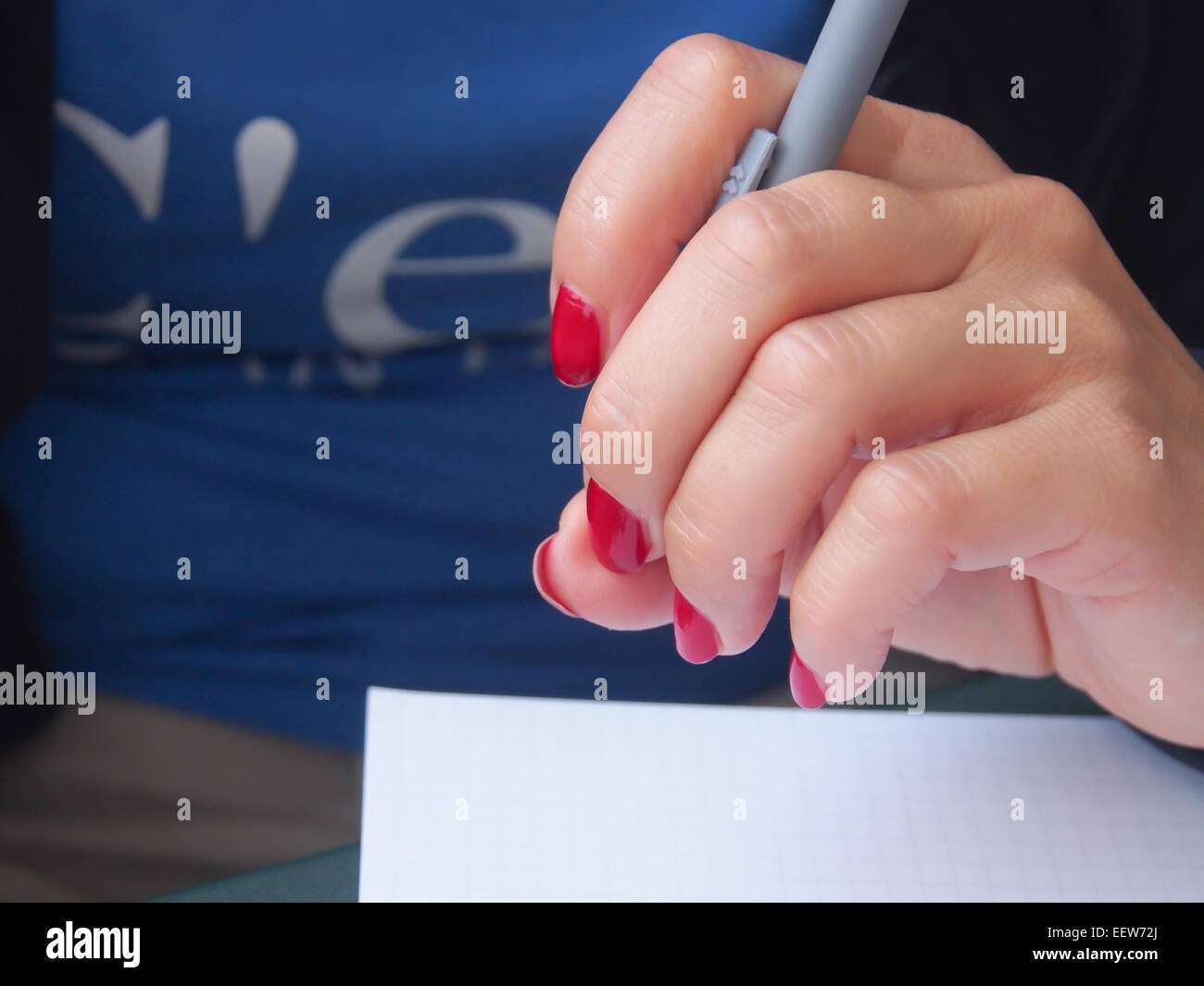 Groomed mighty female hand holding a pen Stock Photo - Alamy