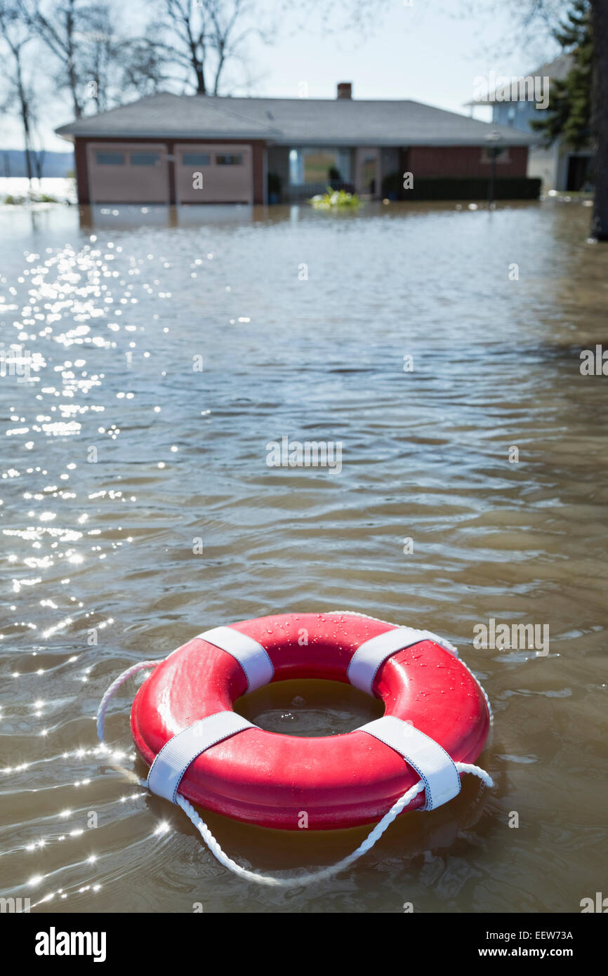 View of flooded house and lifebelt floating on water Stock Photo - Alamy