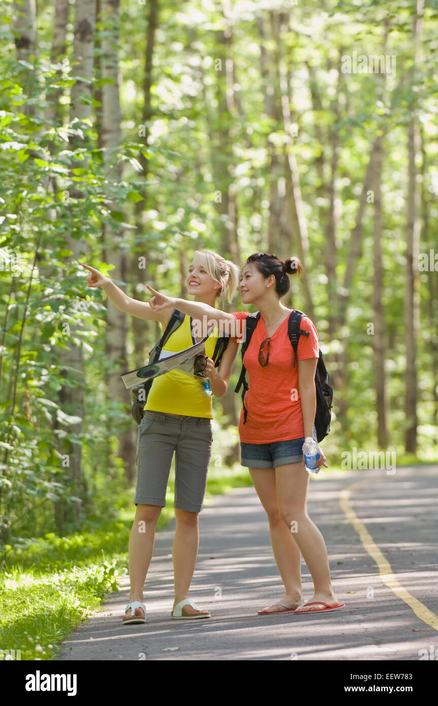 Girl pointing in two directions hi-res stock photography and images - Alamy