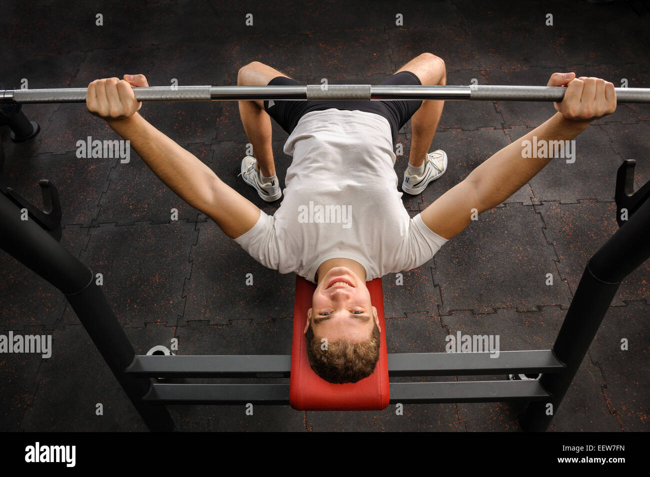 young man doing bench press workout in gym Stock Photo - Alamy