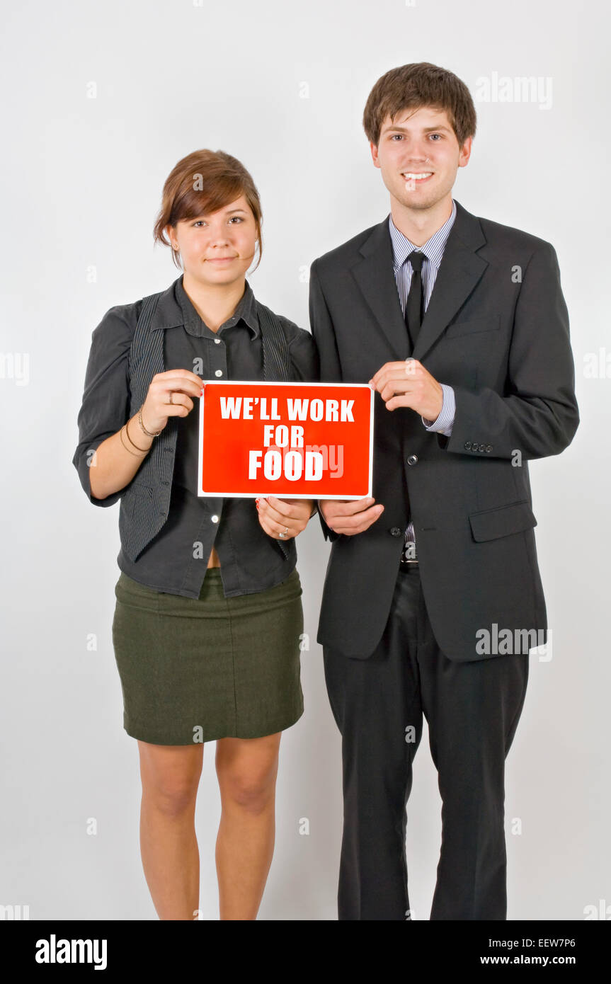 Two people holding a we'll work for food sign Stock Photo - Alamy