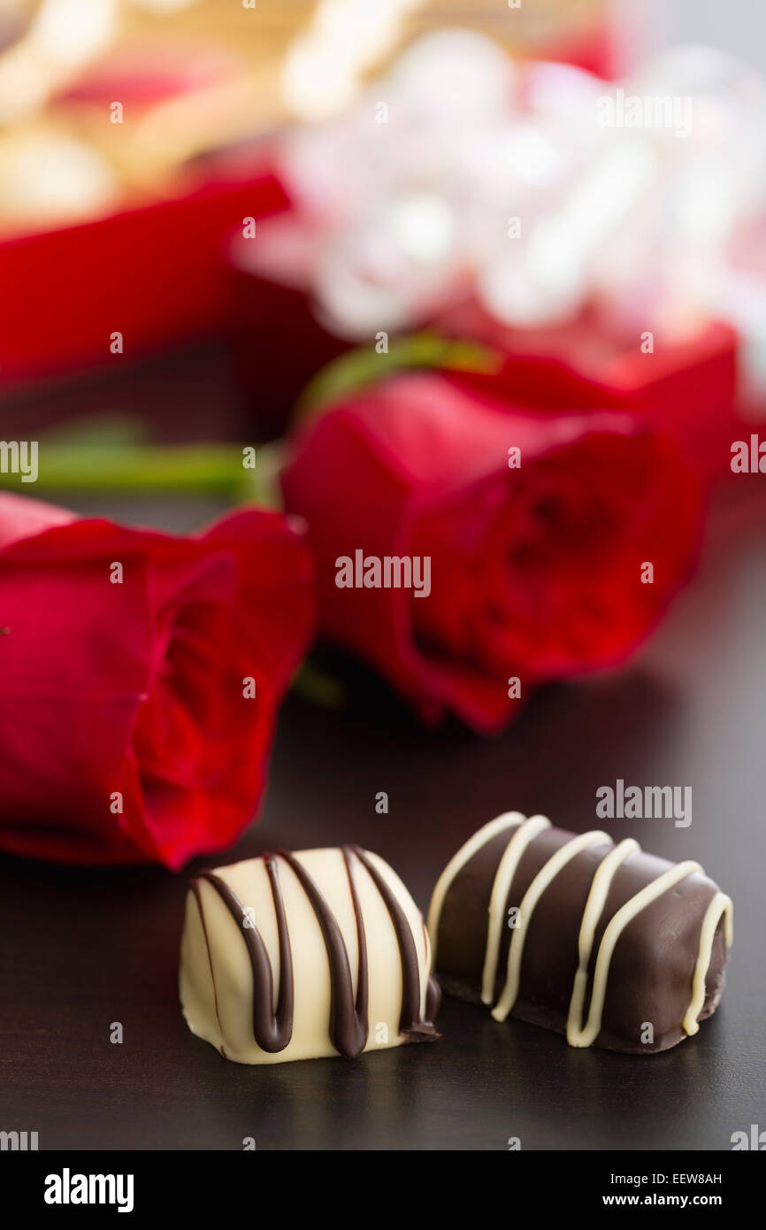 Chocolate candies and red roses Stock Photo - Alamy
