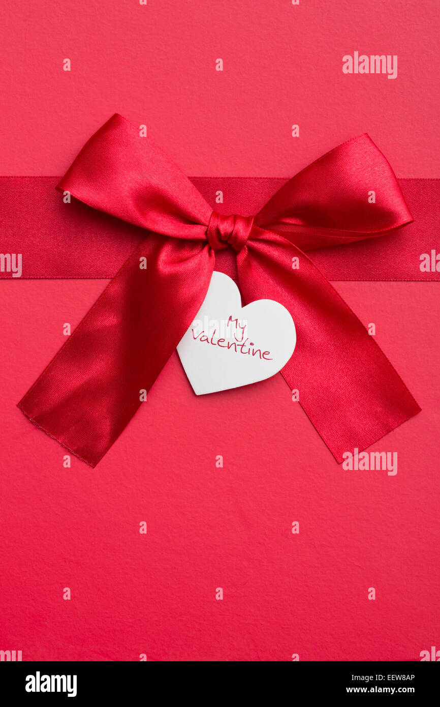 Red ribbon with heart-shaped tag Stock Photo - Alamy