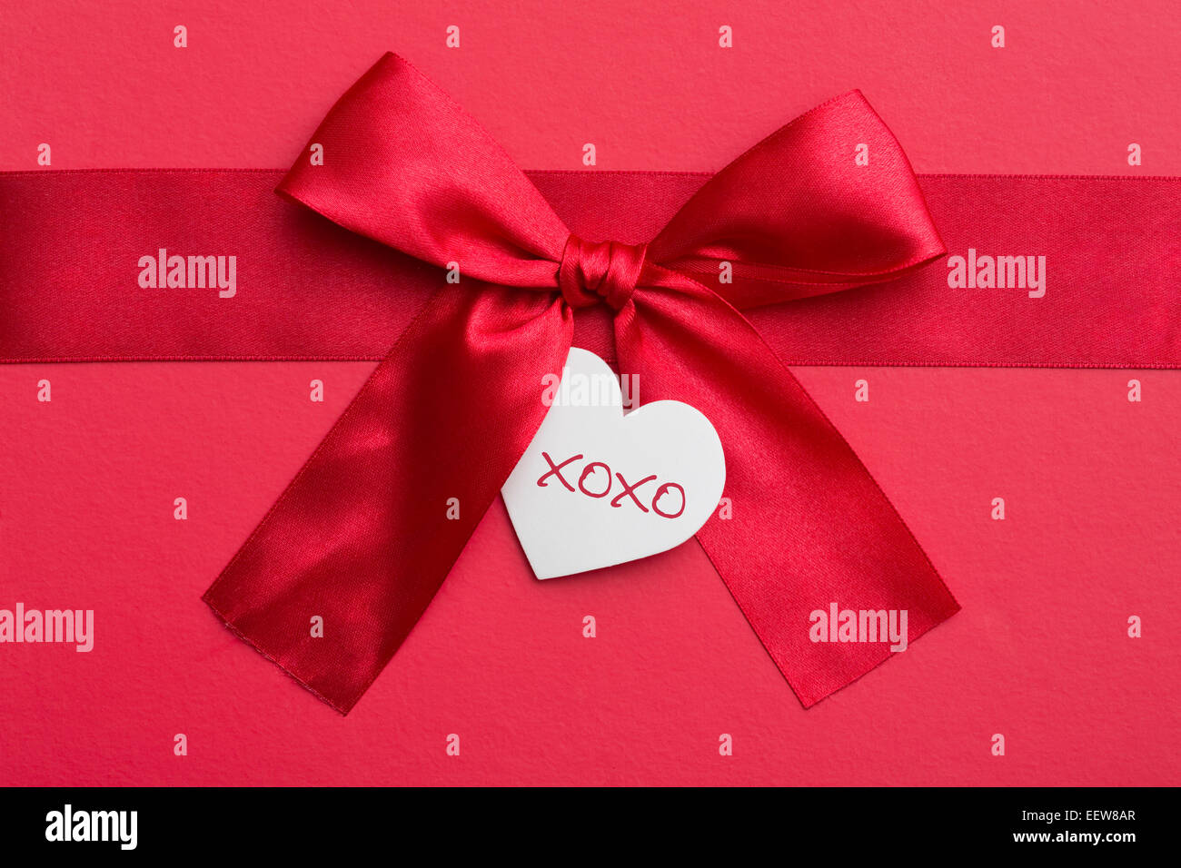 Red ribbon with heart-shaped tag Stock Photo - Alamy