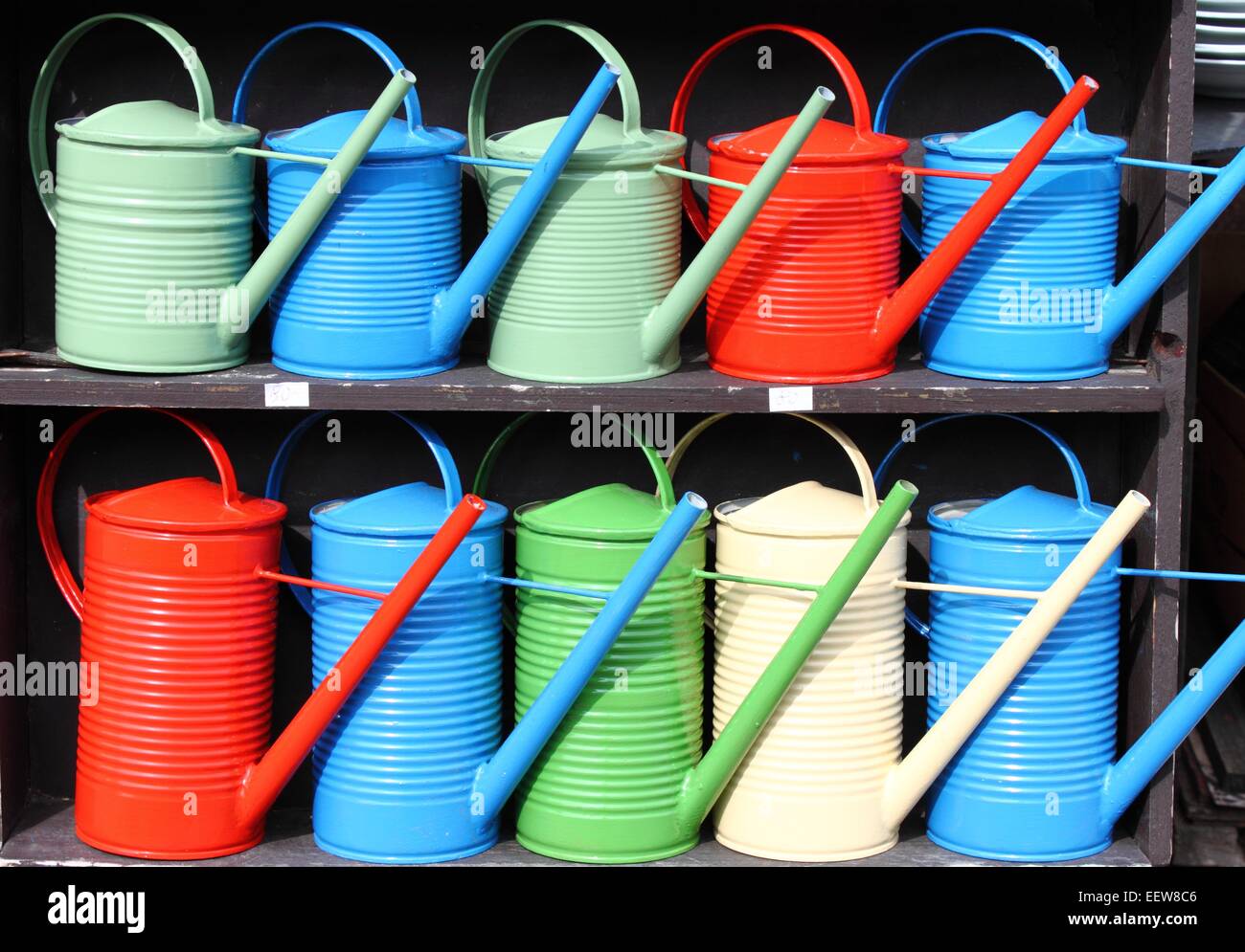 Rows of colorful watering cans Stock Photo - Alamy