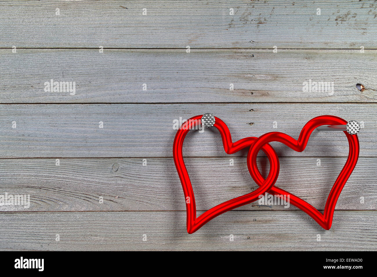 two linked red hearts against the planks background Stock Photo - Alamy