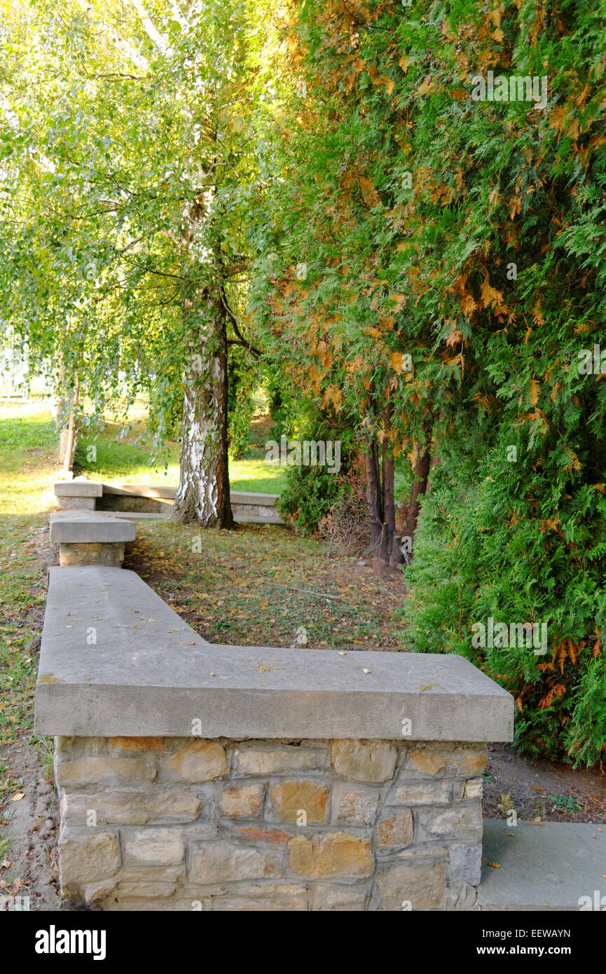 low stone wall in the city park Stock Photo - Alamy