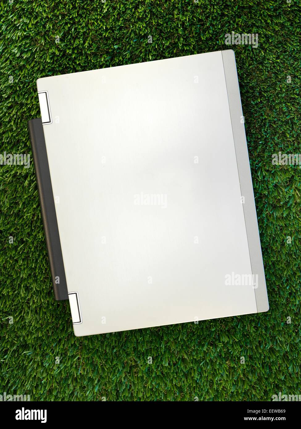 A laptop computer on artificial grass Stock Photo - Alamy