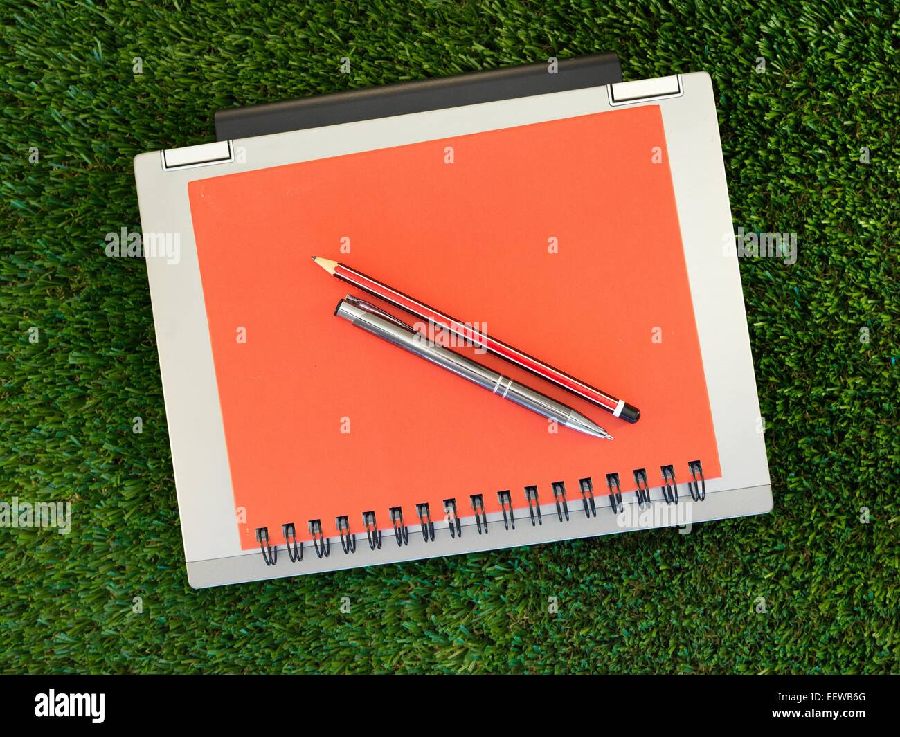 A laptop computer on artificial grass Stock Photo - Alamy