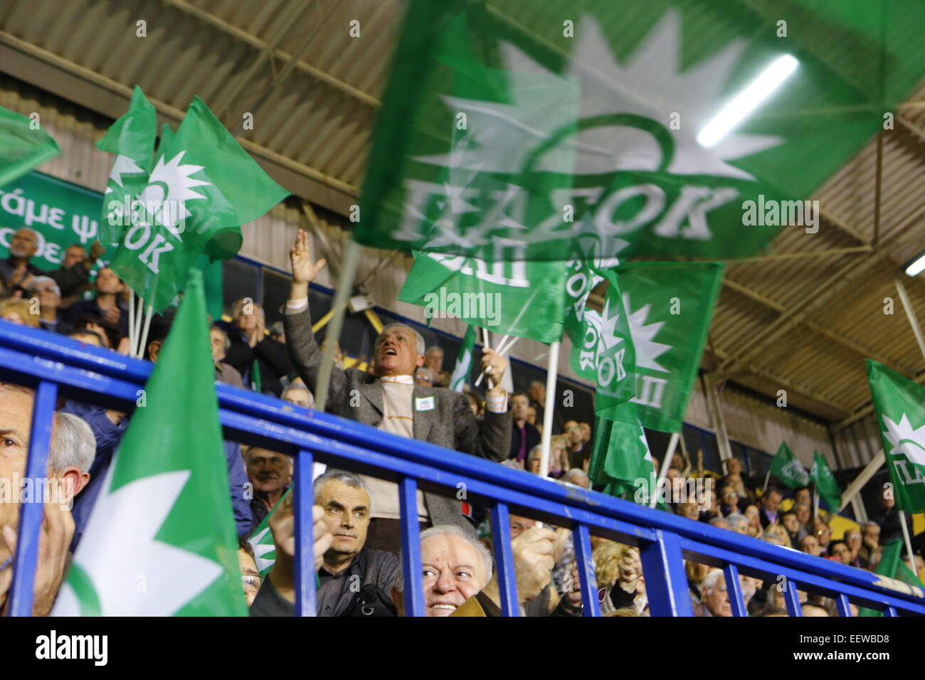 Members of the audience wave green and white PASOK flags. PASOK ...
