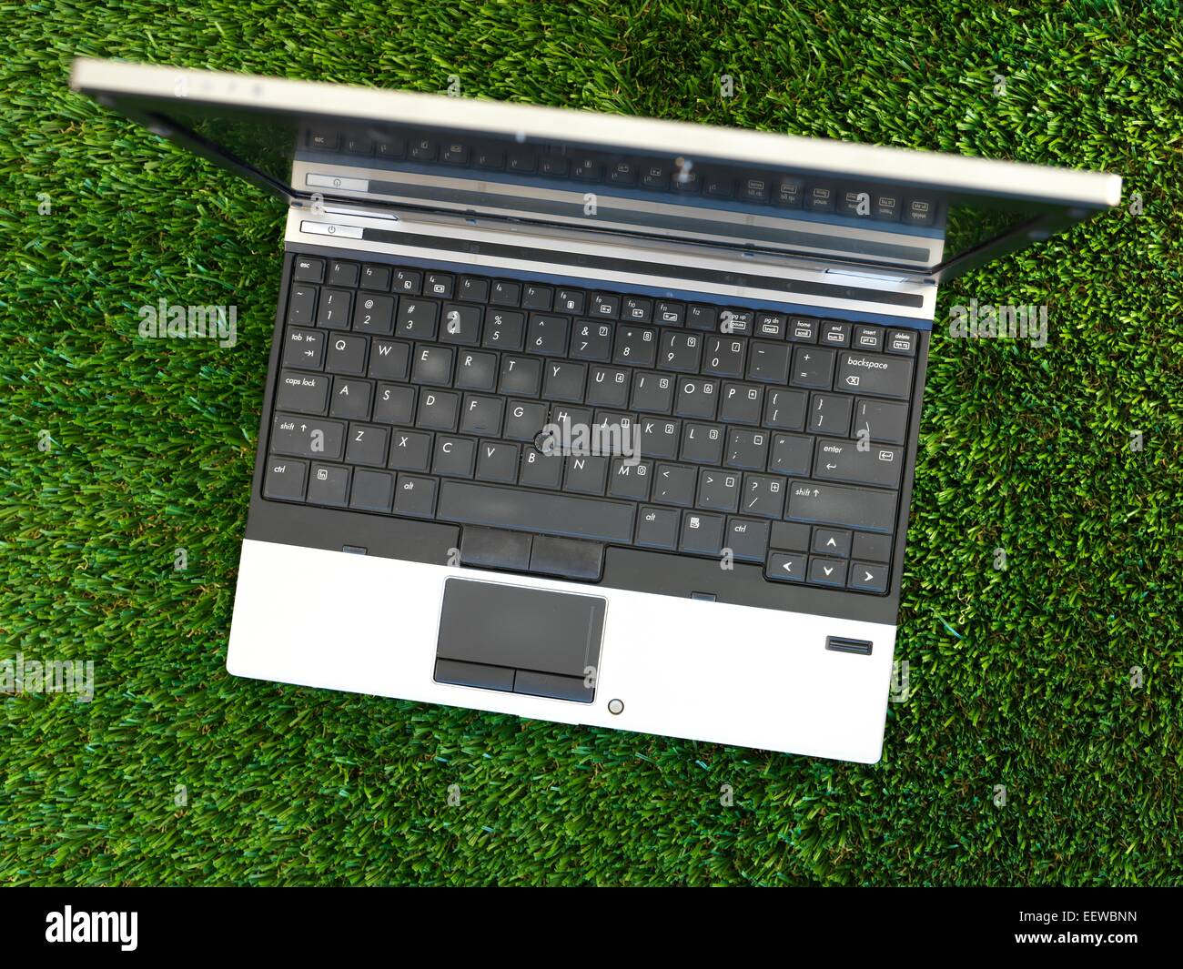 A laptop computer on artificial grass Stock Photo - Alamy