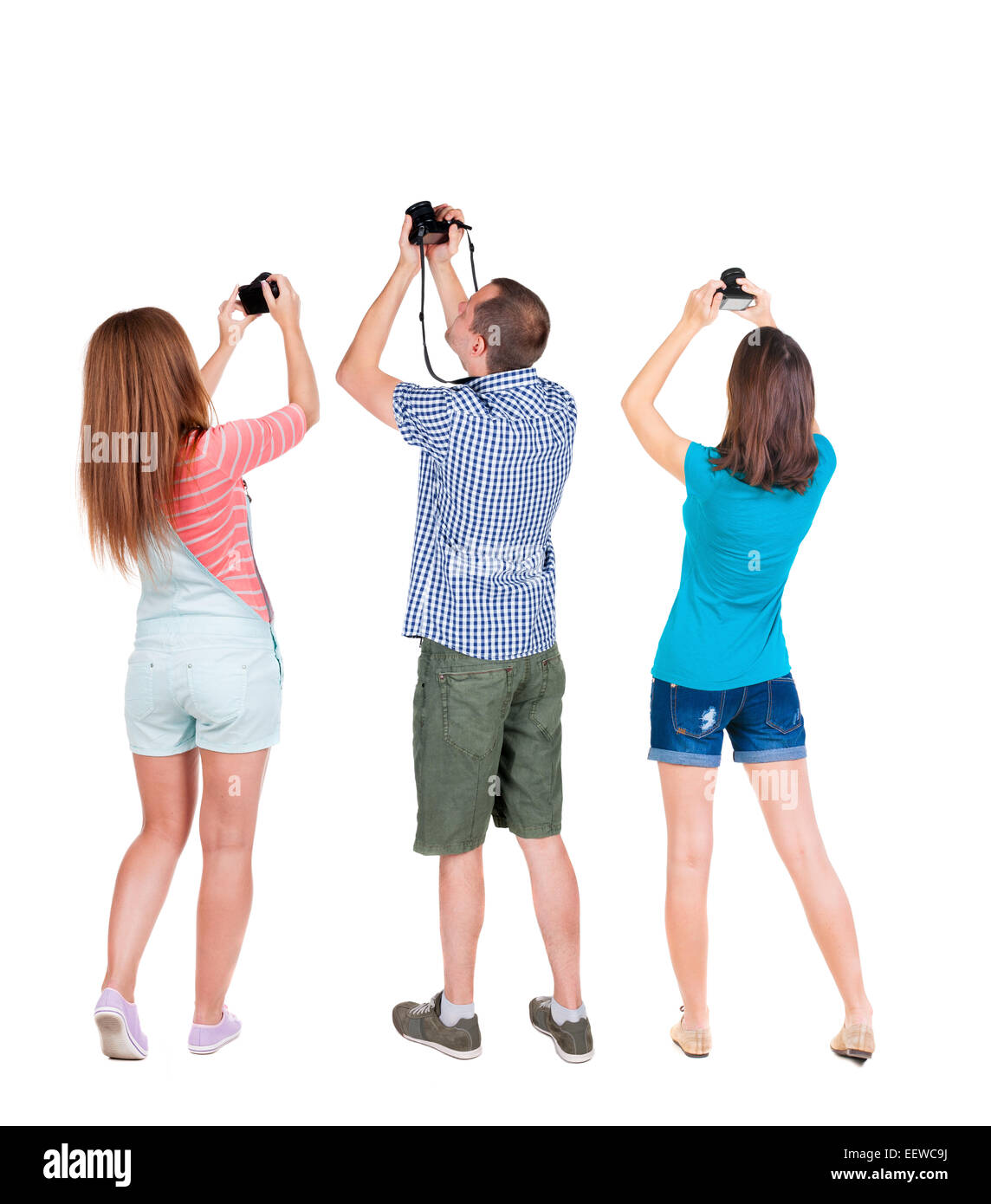 Back view group of people photographed attractions. Rear view team ...